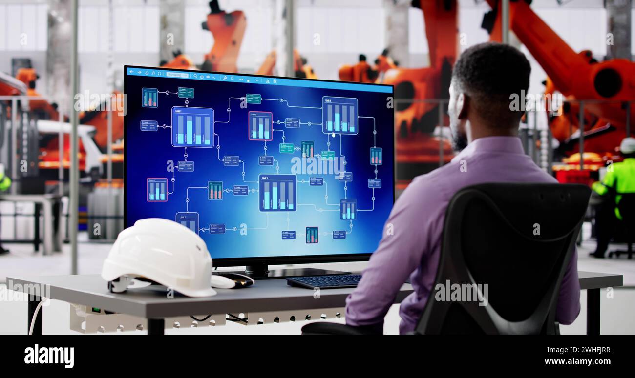 African American Engineer Using Computer In Electric Car Assembly ...