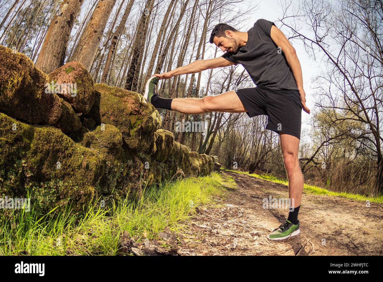 Male runner stretching outdoors Stock Photo - Alamy