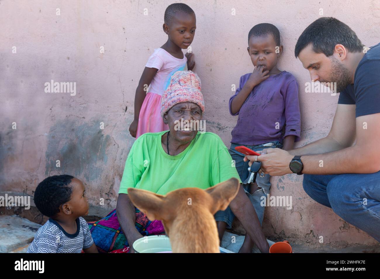 group of village african children in the yard together with granny, ngo ...