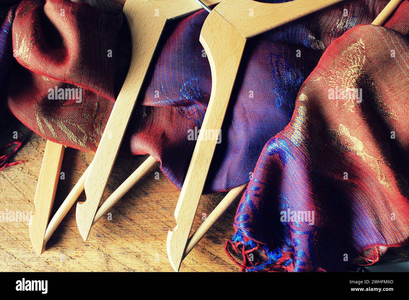 Wooden empty clothes hangers on wooden background. What nothing to wear ...