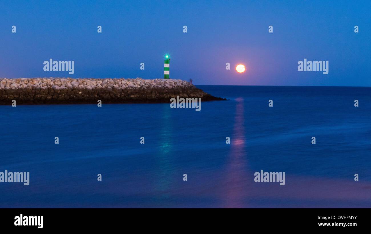 Moon rising in Lagos harbour Stock Photo - Alamy