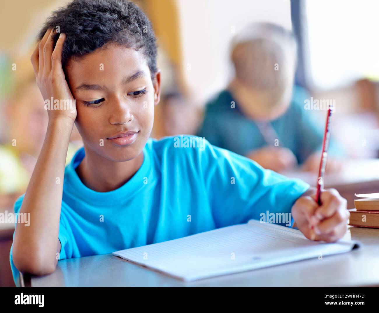 Student, boy and writing notes for studying in classroom, book and ...
