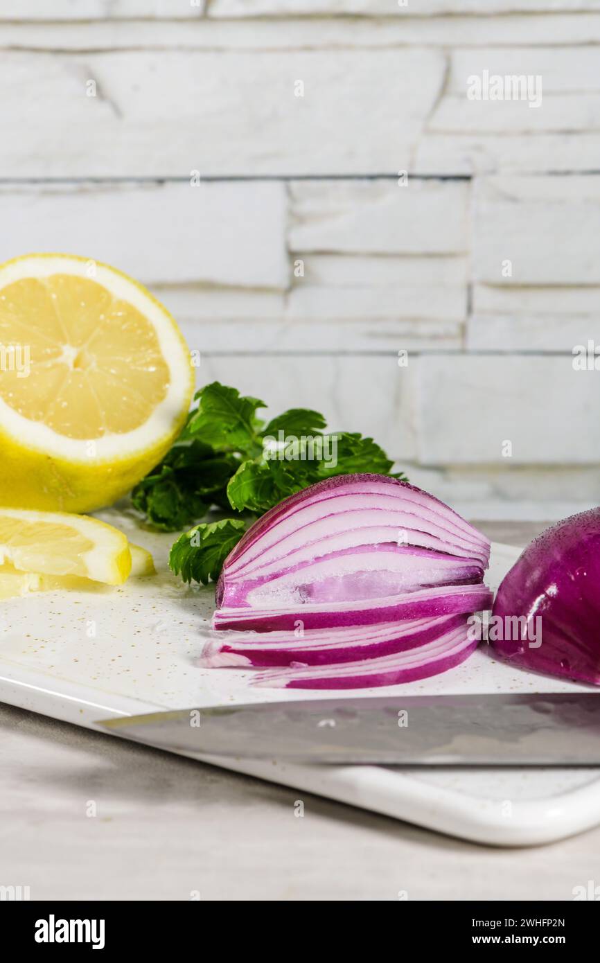 Sliced red onion, lemon and parsley leaves Stock Photo - Alamy