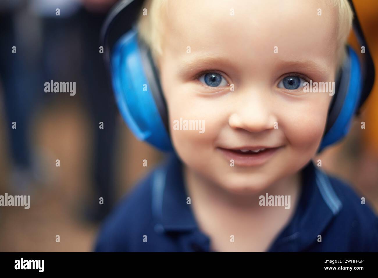 Baby, closeup and smile for portrait with headphones for noise at ...