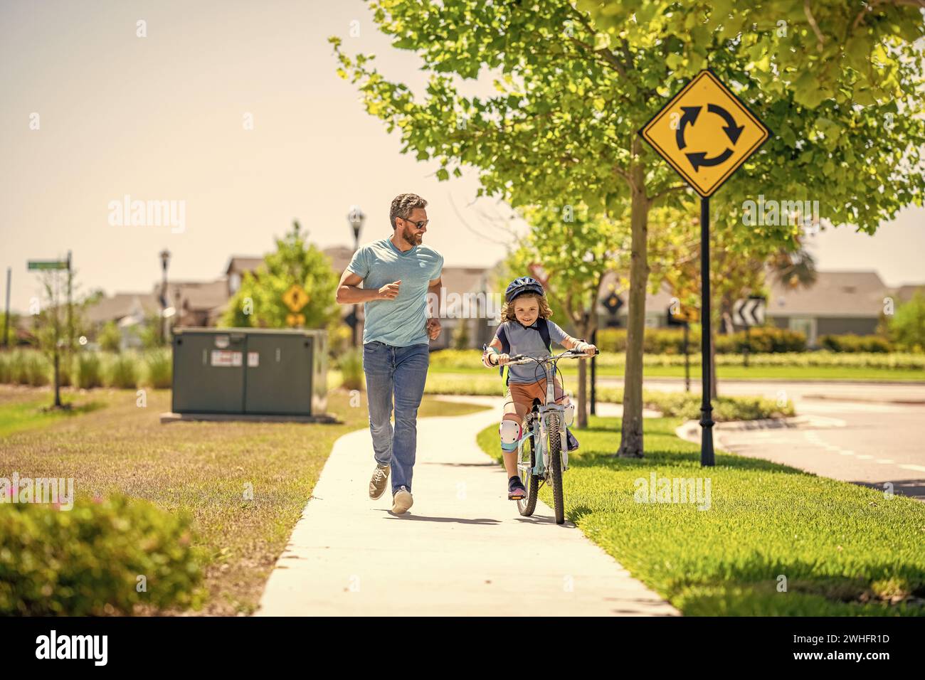 dad and son on biking adventure. dad and son duo pedaling through ...