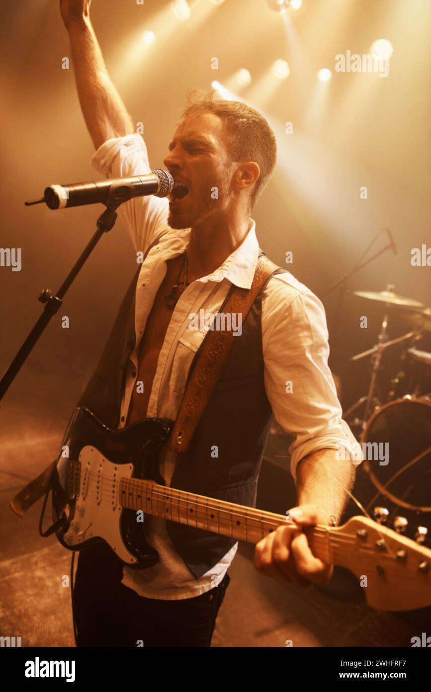 Night, singer and guitar with man on stage for music, performance and ...