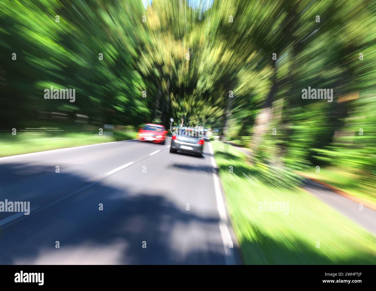 Country road with cars in blurred motion Stock Photo - Alamy