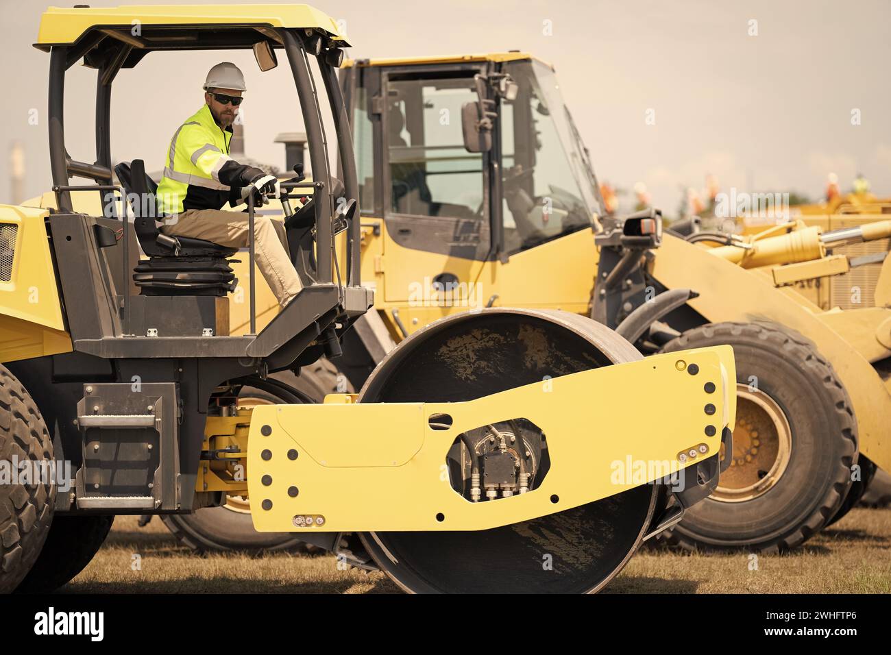 busy worker man in construction equipment. construction worker drive ...