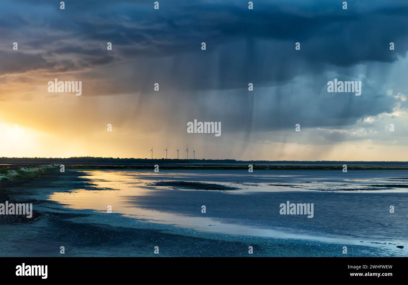 Dramatic rain storm over lake at sunset Stock Photo - Alamy