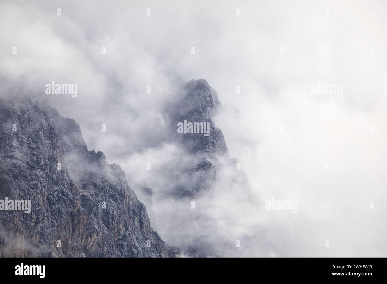 Alpine rocks in dense clouds Stock Photo - Alamy