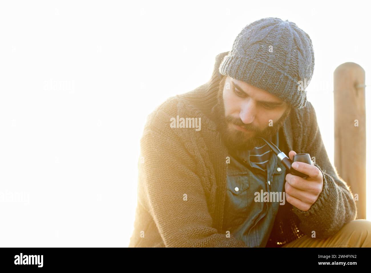 Young, man and smoking a pipe in outdoor, thinking and tobacco habit in ...