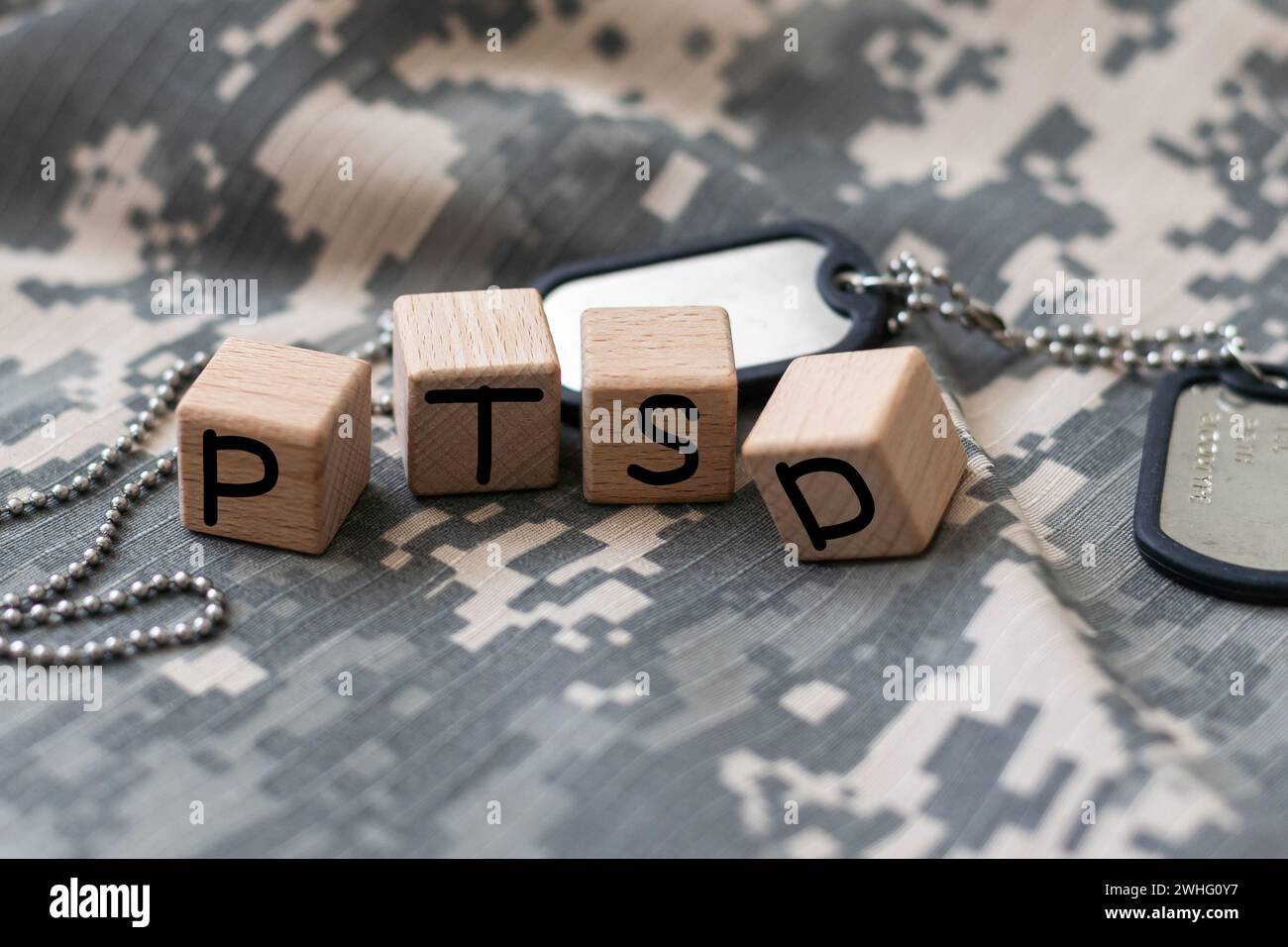 The letters PTSD on wooden blocks on a black background. Minimal ...