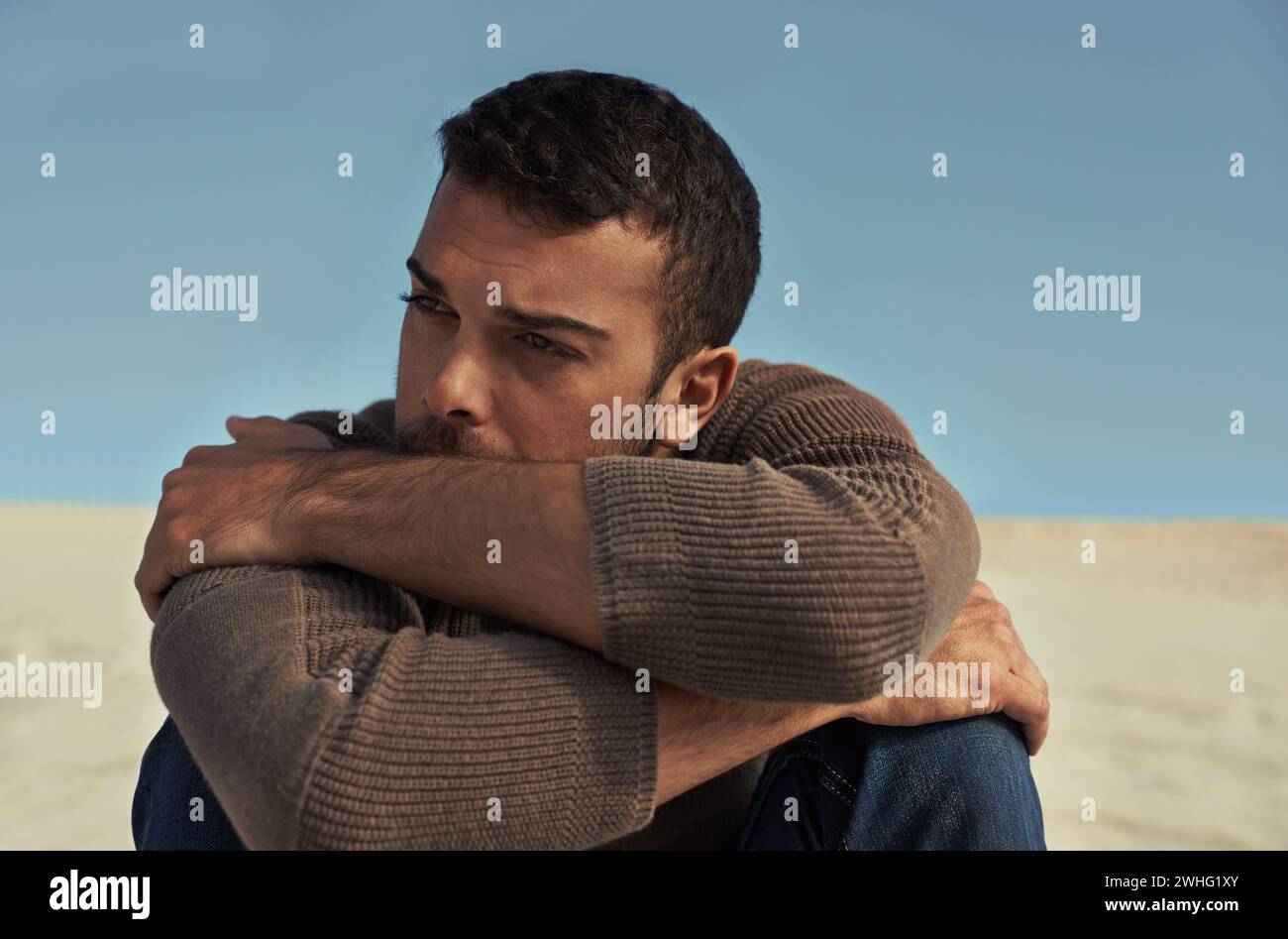 Worried man sitting alone outdoors hi-res stock photography and images ...