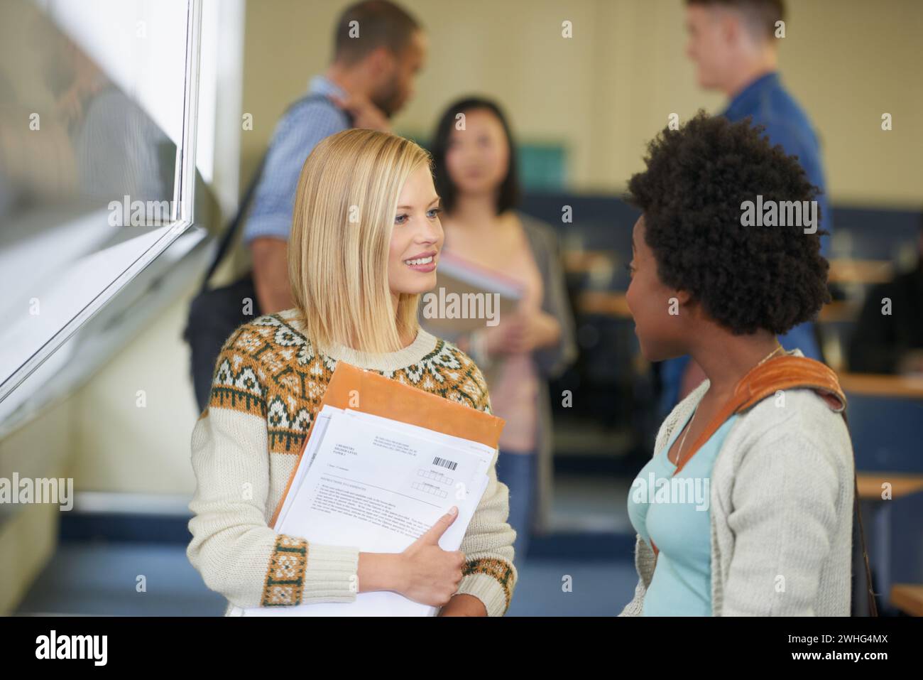 Male friends talking hall hi-res stock photography and images - Alamy