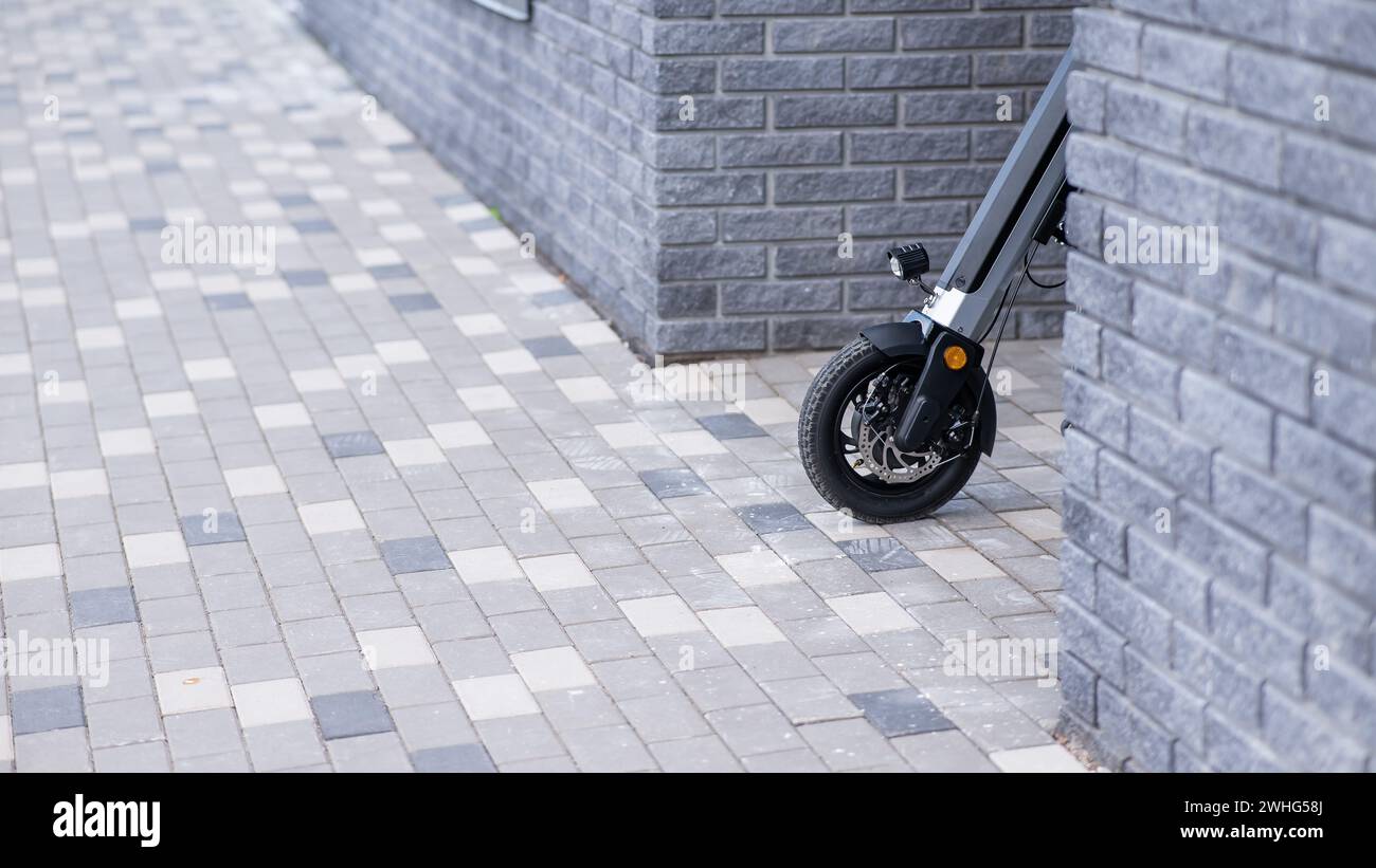 A wheelchair with an assistive device for manual control comes around ...