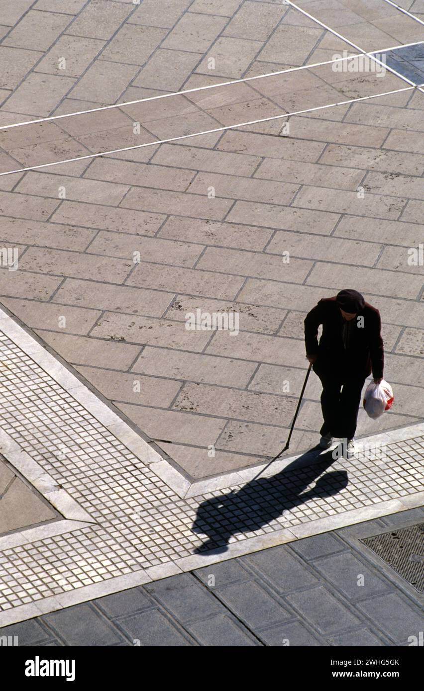old people walking on pavement with long shade symbolic oldness Stock ...