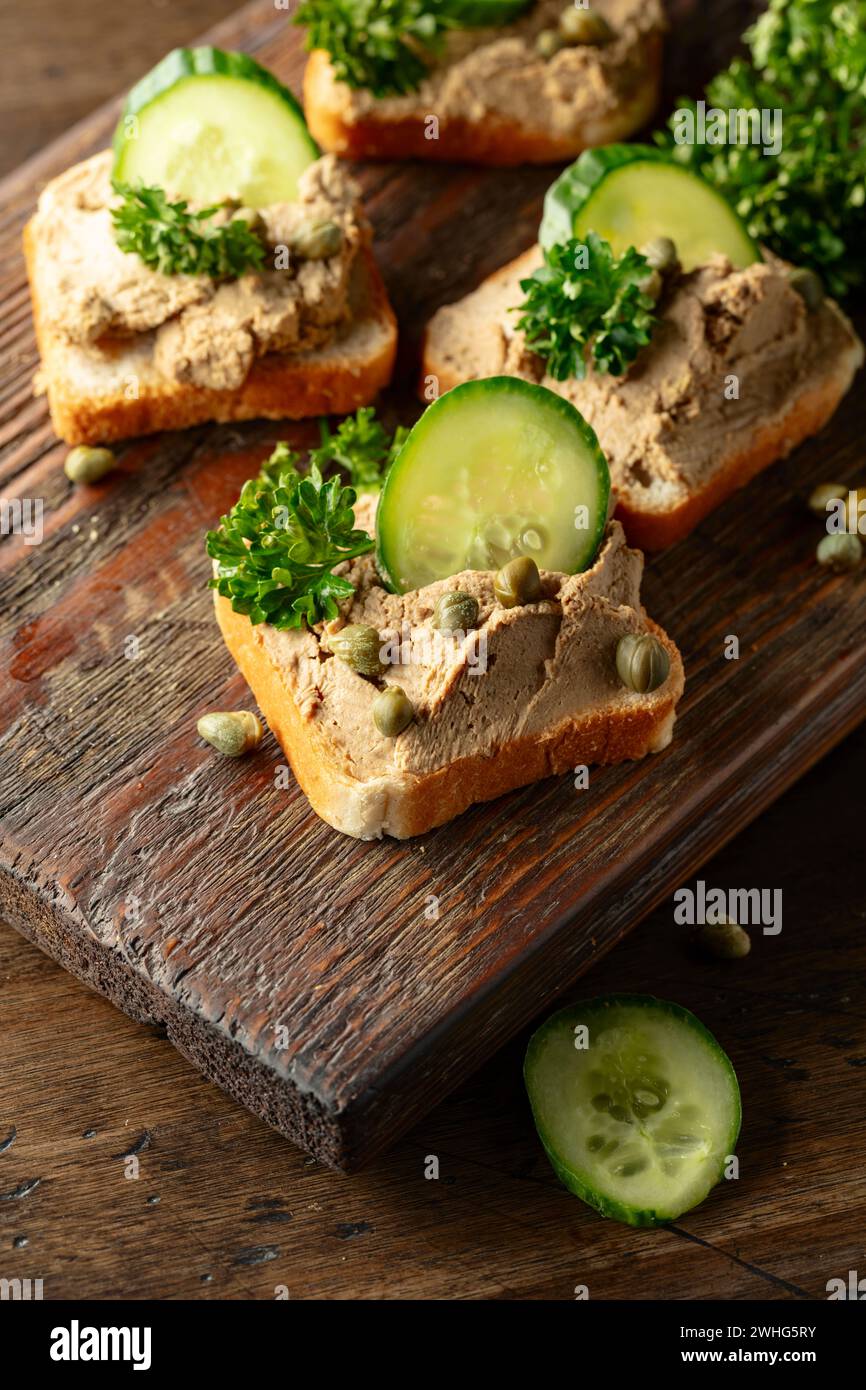 Toasts with pate on a old cutting board. Open sandwiches with pate ...