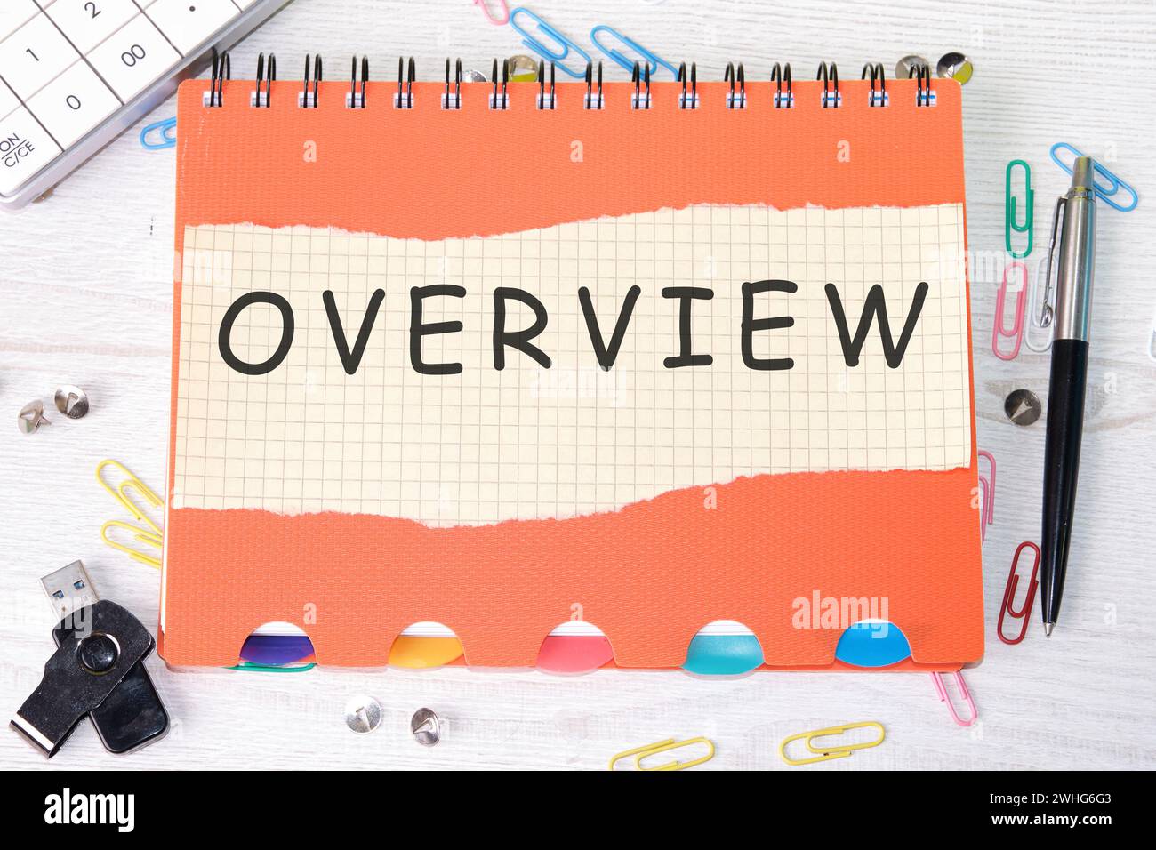 Overview word is written on a sheet in a cage lying on a notebook on ...