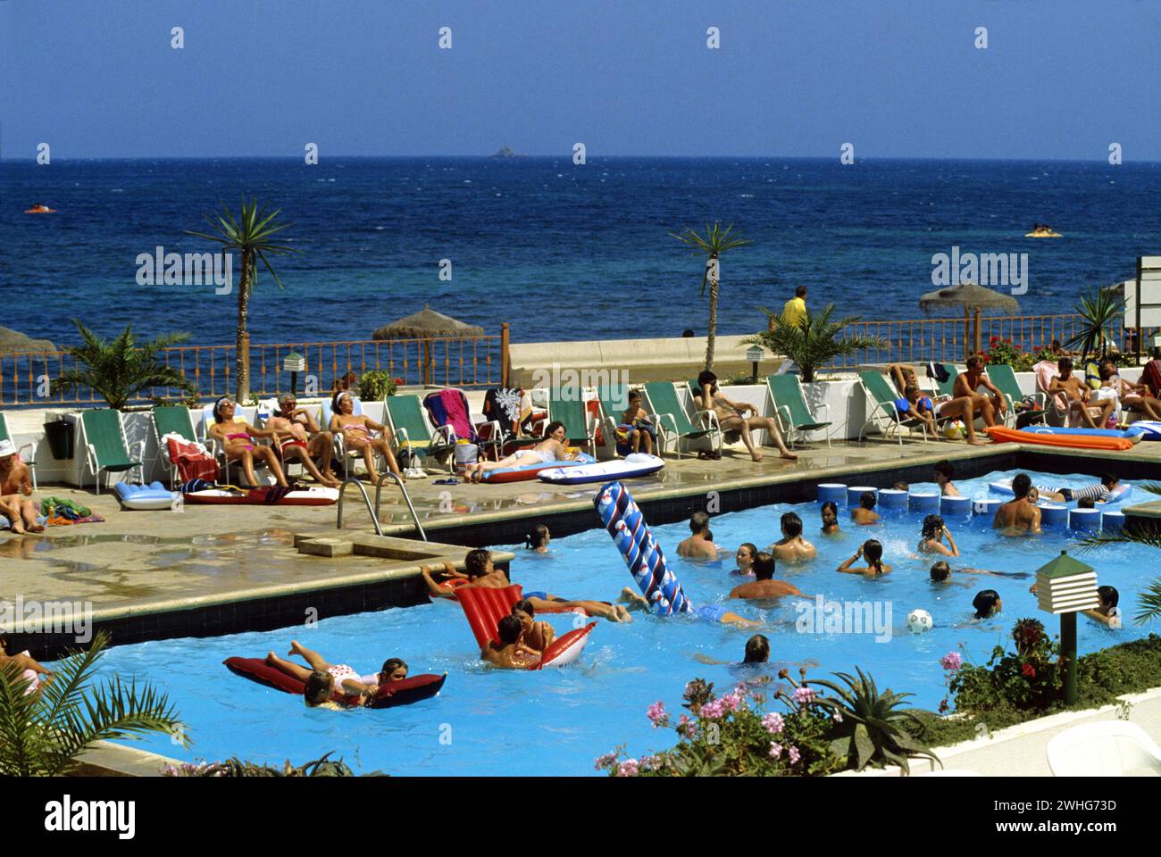 summer holidays hotel ibiza baleares islands crowded pool blue sky and ...