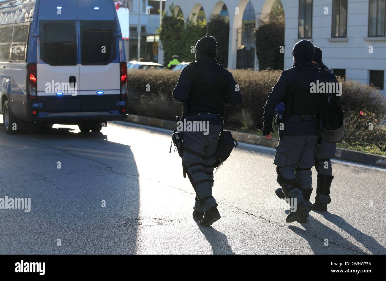 police in riot gear on the street of city during riot and a van Stock ...