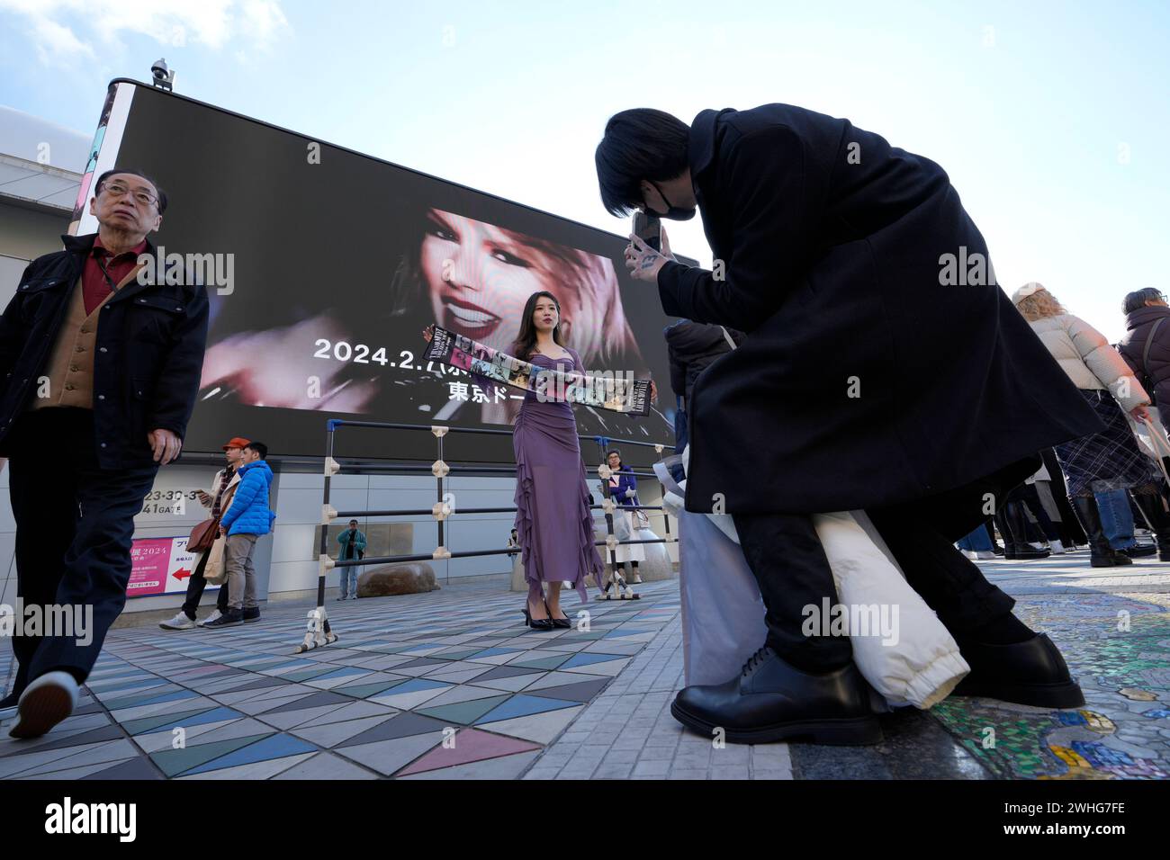 A woman poses for a photo before Taylor Swift's concert at Tokyo Dome in Tokyo, Saturday, Feb ...