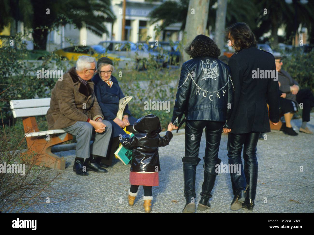 french young family with kid rocker look passing front a senior couple ...