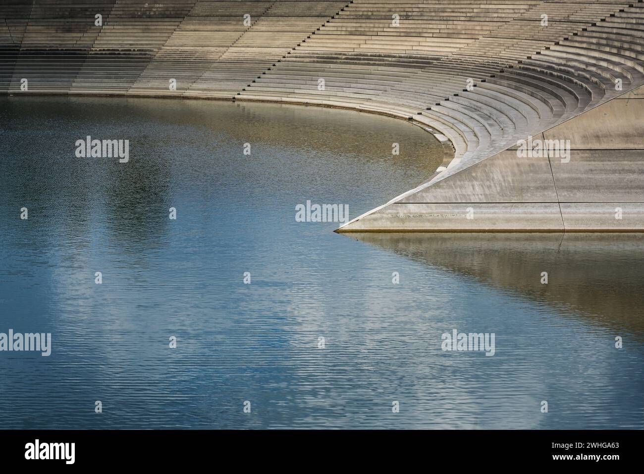 The curve, semicircular staircase for sitting made of concrete leads to ...