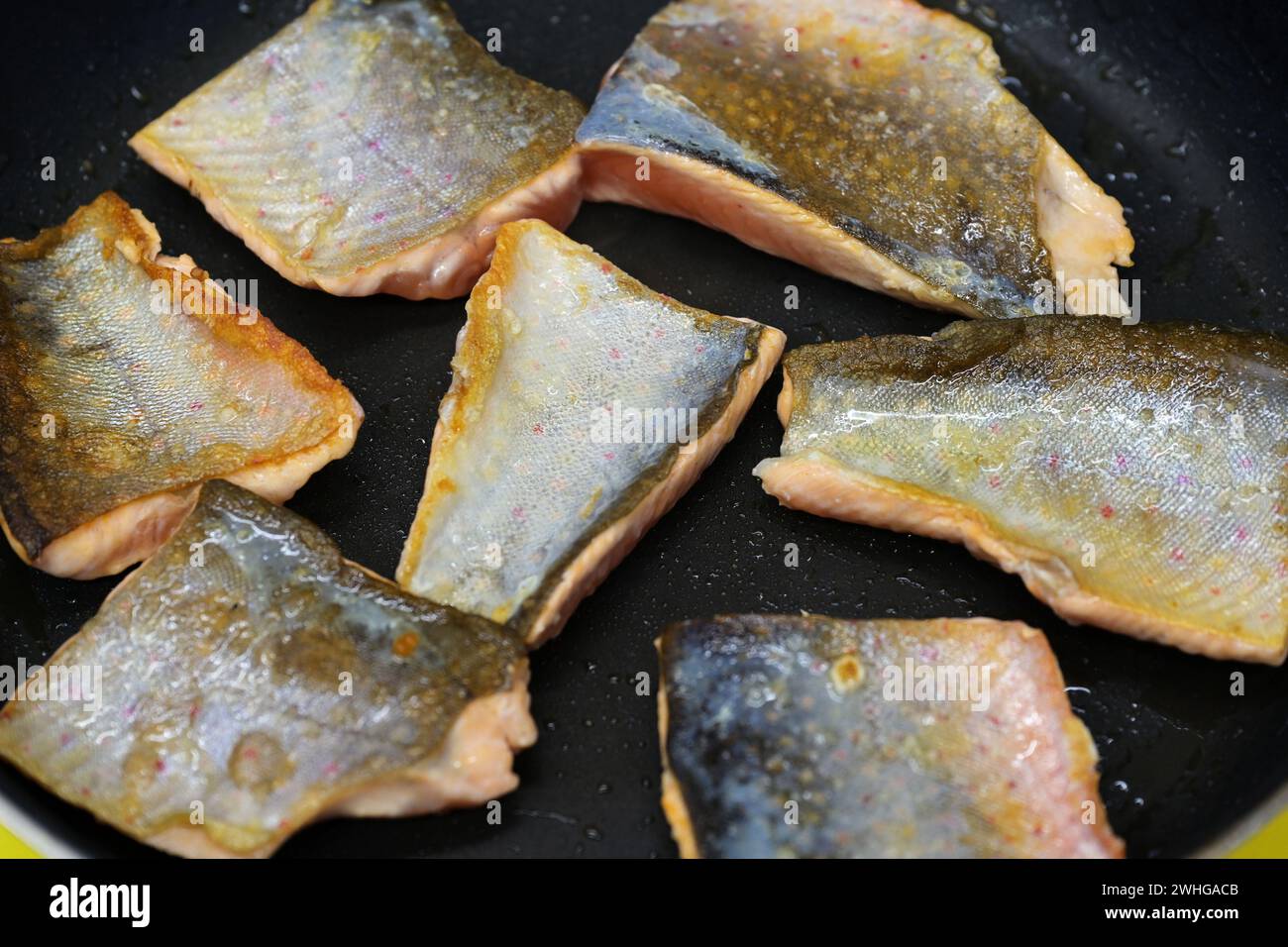 Char fish fillets fried on the skin and just turned over in a black pan ...