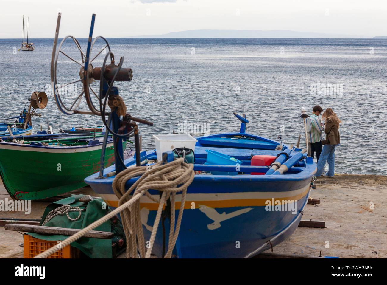 Traditional slipway with fishing boats hauled out in the pretty little ...