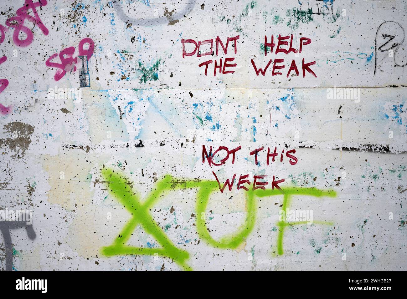 Don't help the weak graffiti Stock Photo - Alamy
