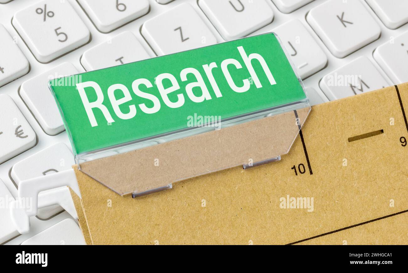 A brown file folder labeled Research Stock Photo - Alamy