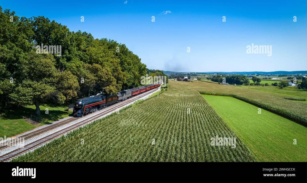 Drone View of a Steam Passenger Train Approaching a Track Switch With ...
