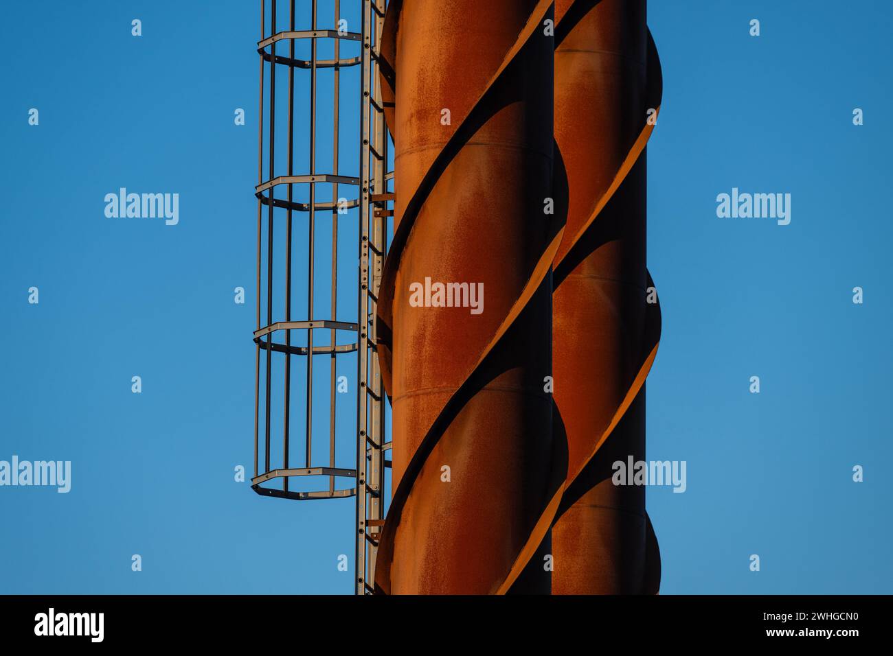 Rusty iron smokestack with ladder Stock Photo - Alamy