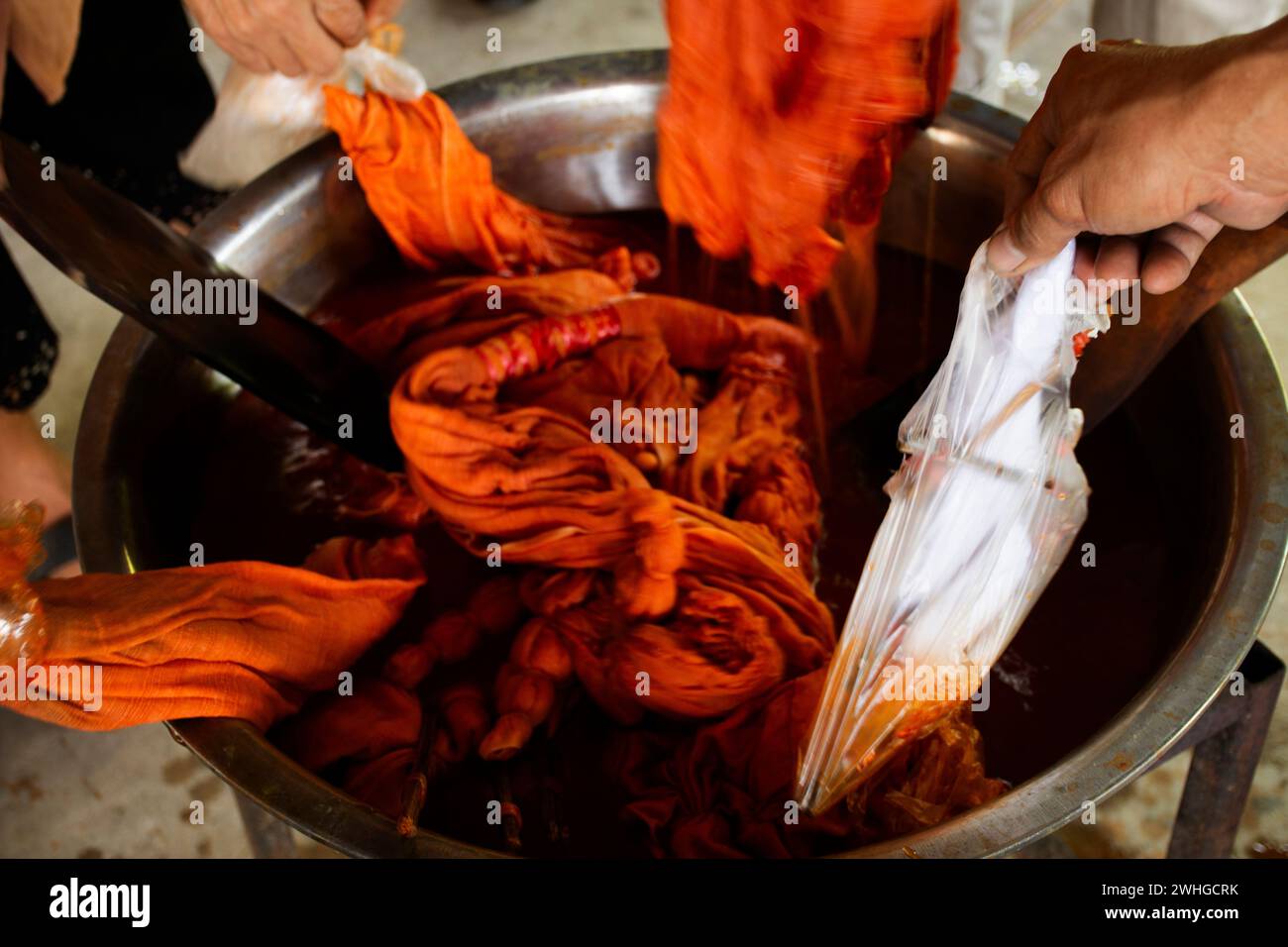 Thai people study learning batik ikat and tie dye natural orange color ...