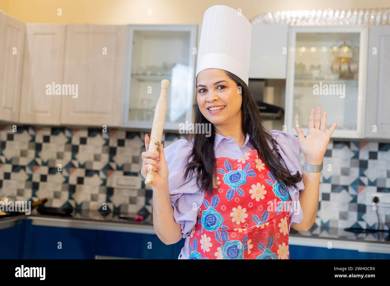 Beautiful indian woman dressed in cook uniform wearing a apron, chef ...