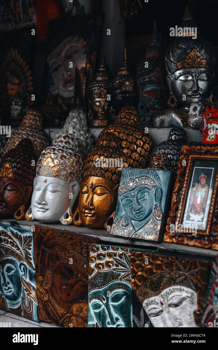 Handmade gold plated Buddha face masks on a counter in a street shop on ...