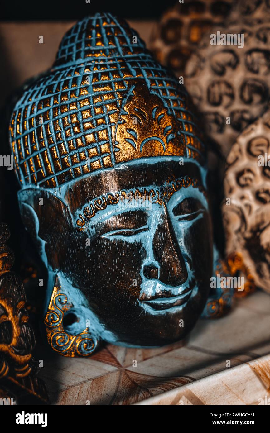 Handmade blue gold plated Buddha face mask on a counter in a street ...