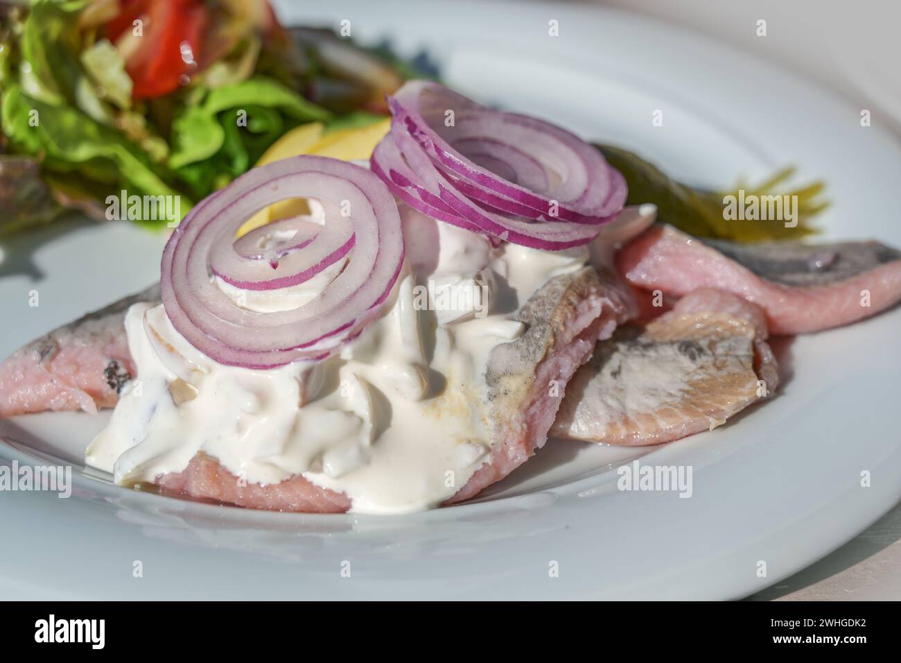 Salted young herring fillet also called soused with apples and sour ...