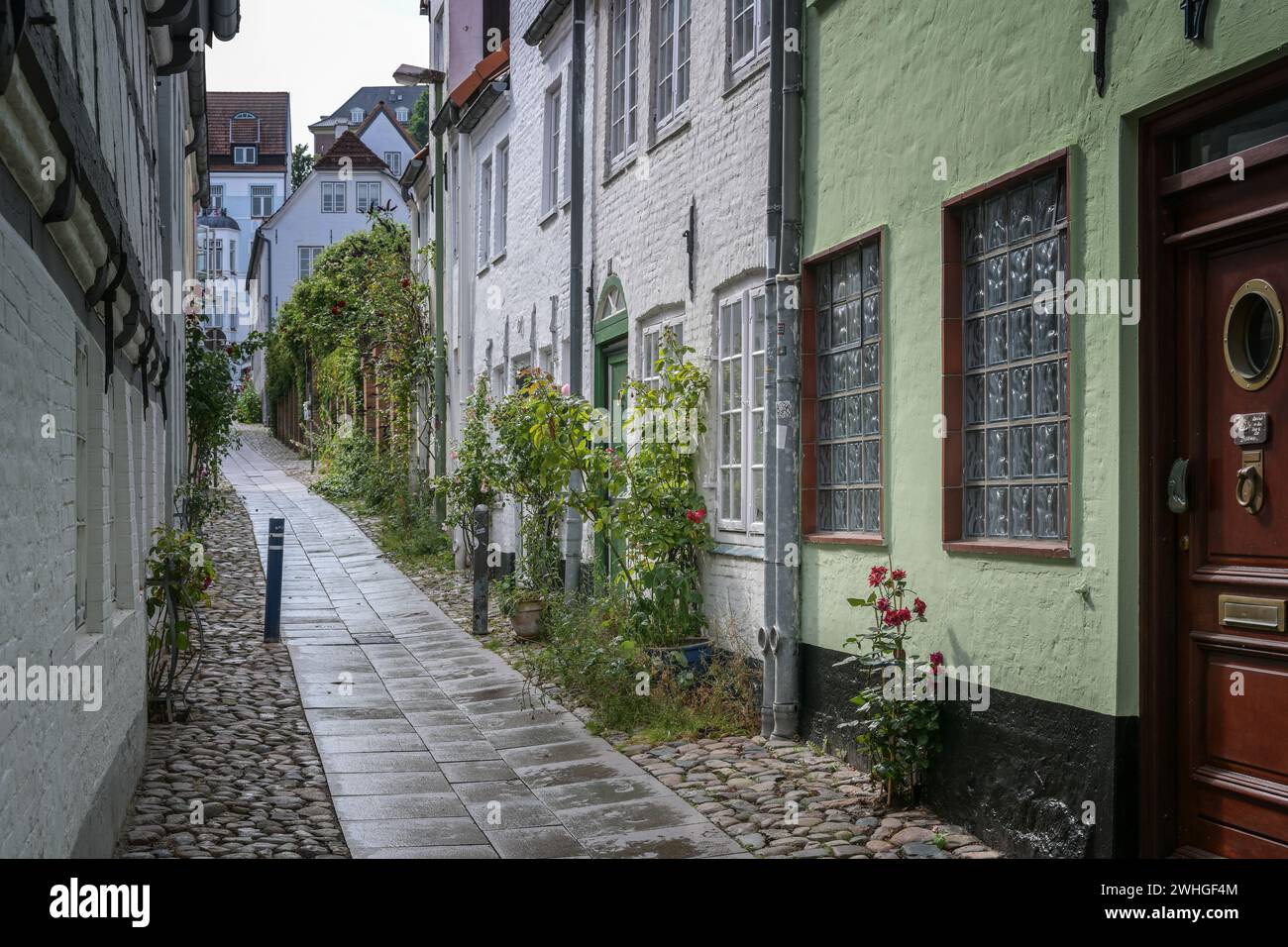 Flensburg old town, typical narrow alley between small city houses with ...