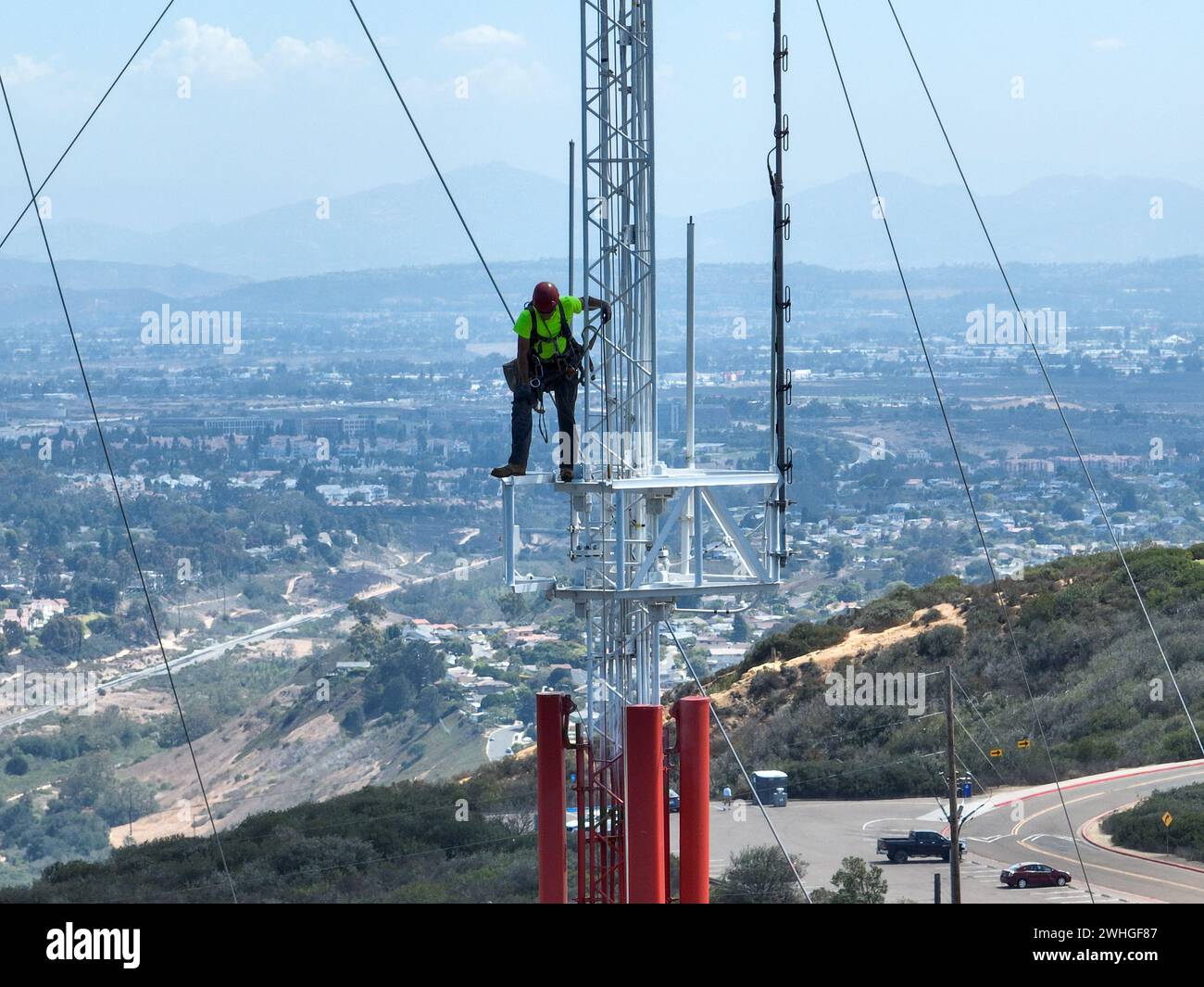 Engineer with safety equipment on high tower for working telecom ...