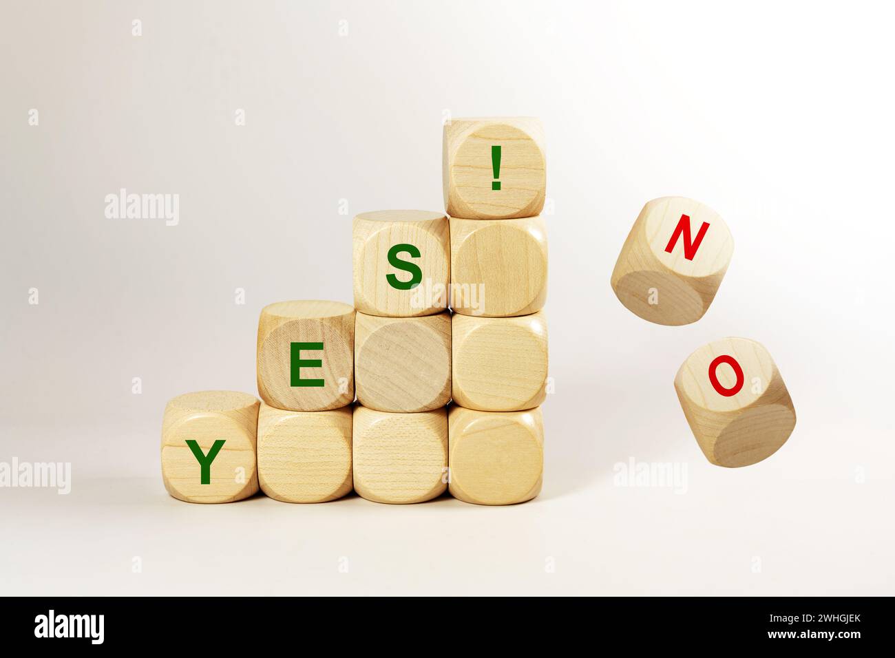 Stacked wooden cubes with the word YES, two are falling with NO ...