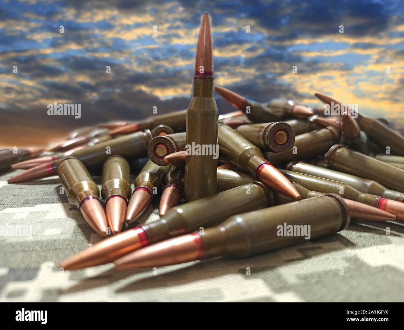 Cartridges for the Kalashnikov assault rifle. War concept. Pile of ...