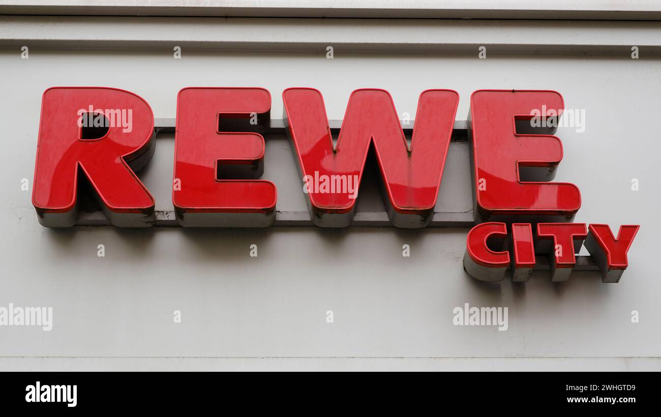 Facade with sing and logo of Rewe Stock Photo - Alamy