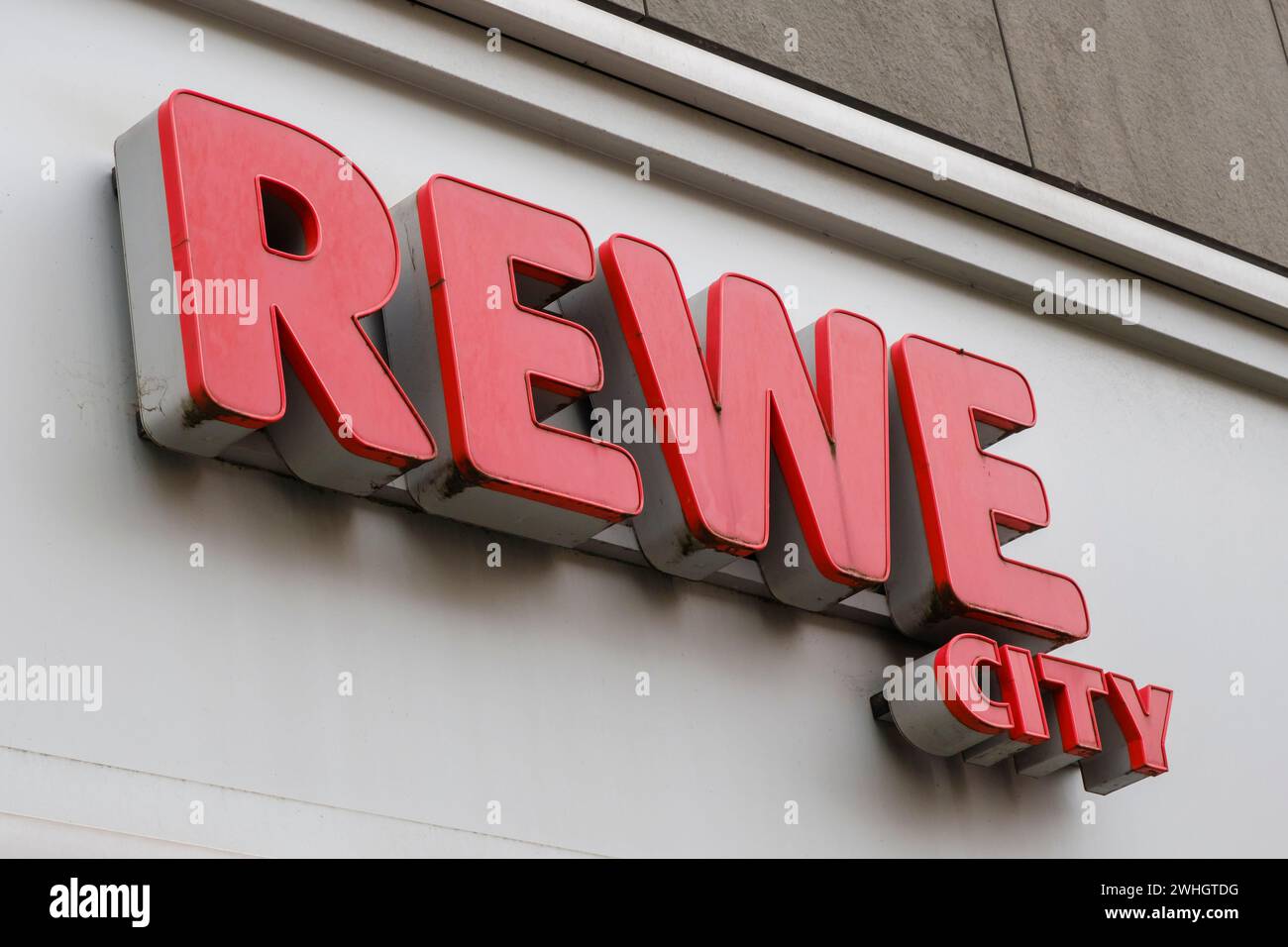 Facade with sing and logo of Rewe Stock Photo - Alamy