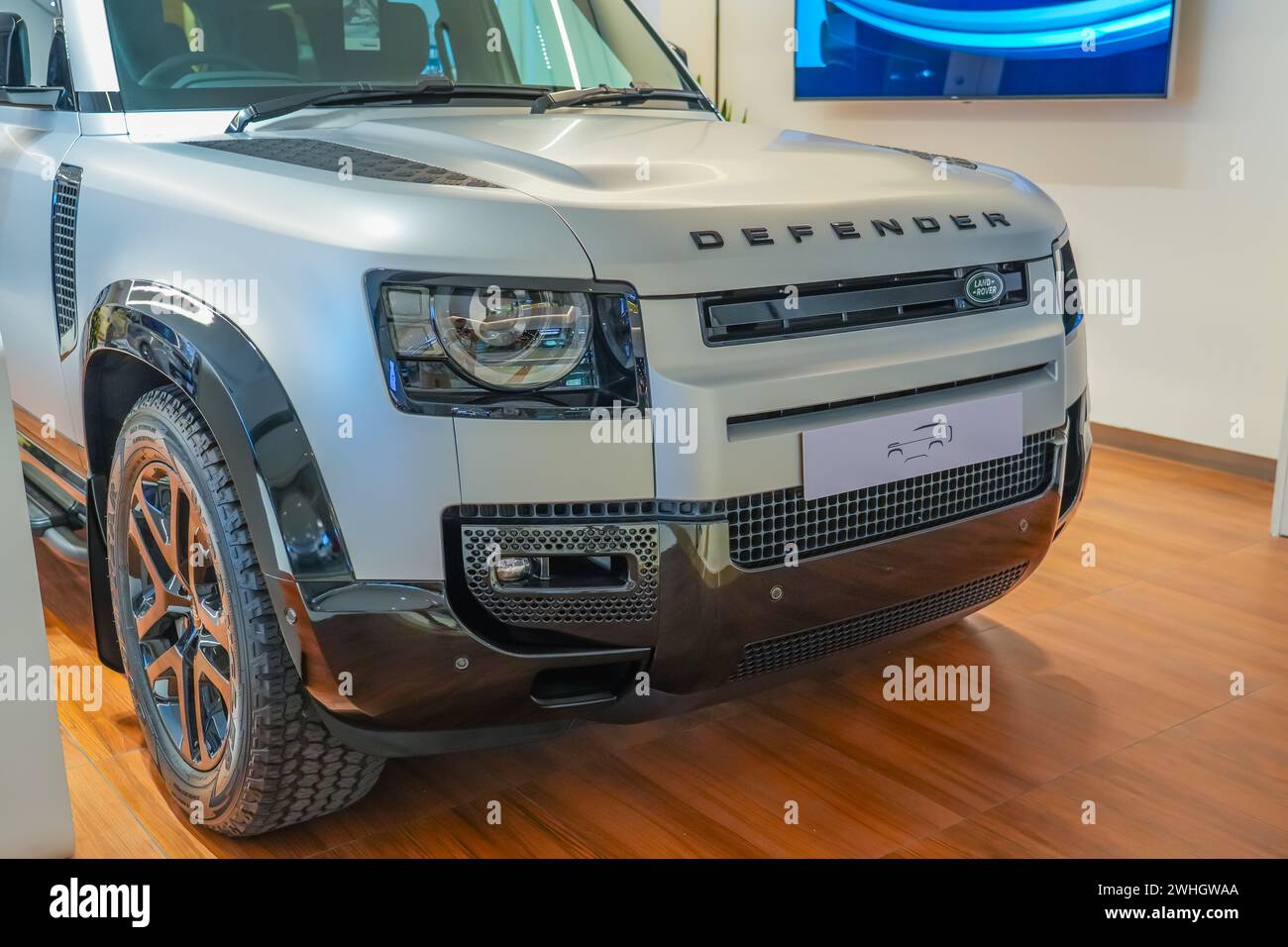 Land Rover Defender silver gray in the showroom on the shop showcase ...