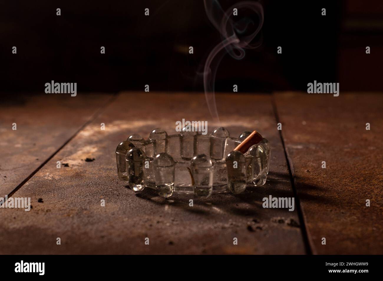 one cigarette butt smoking in the ashtray Stock Photo - Alamy