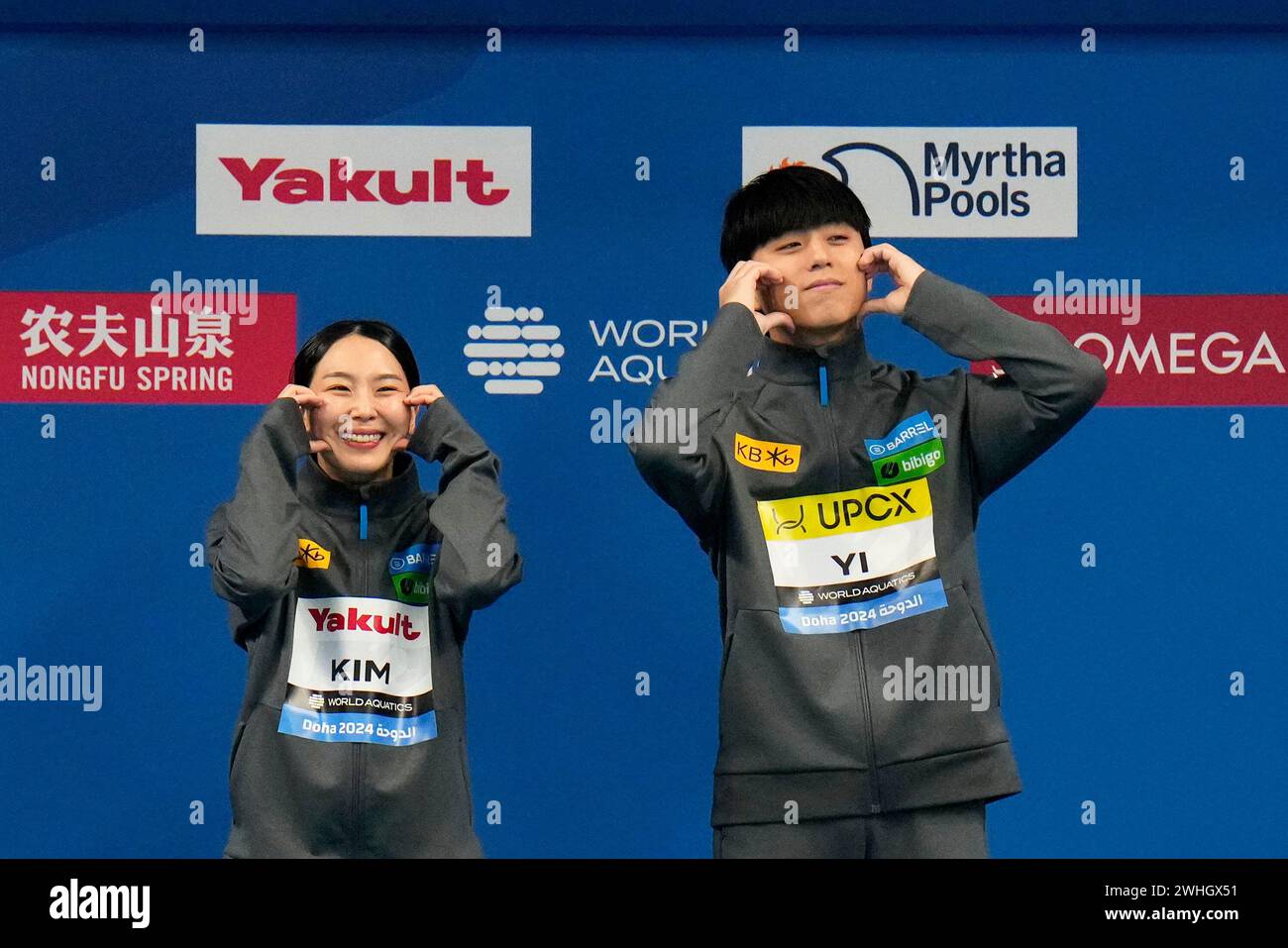 Yi Jaegyeong and Kim Suji of South Korea acknowledge the fans after winning the bronze medal in ...