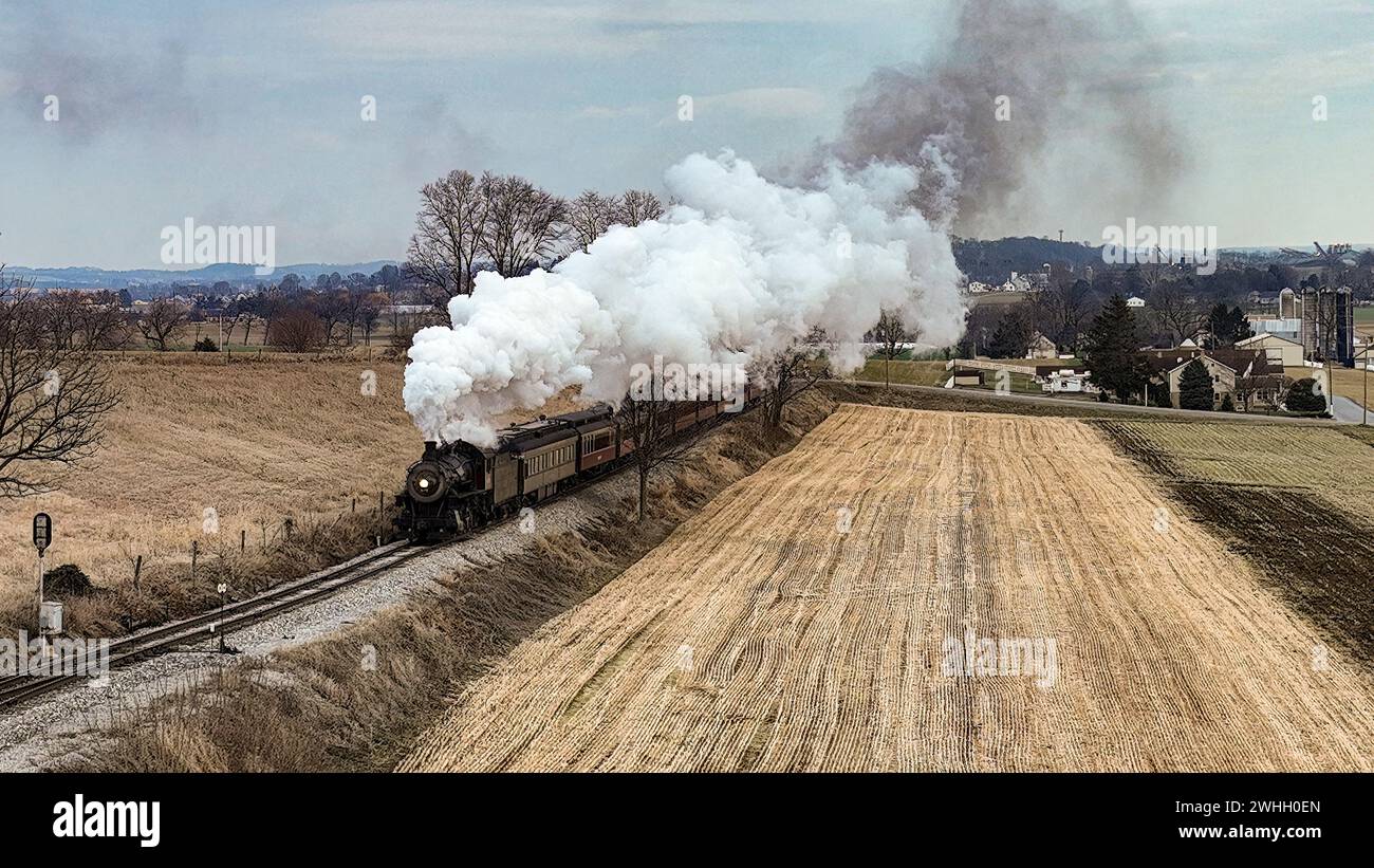 Drone View of a Steam Locomotive Approaching Traveling Thru Fields and ...