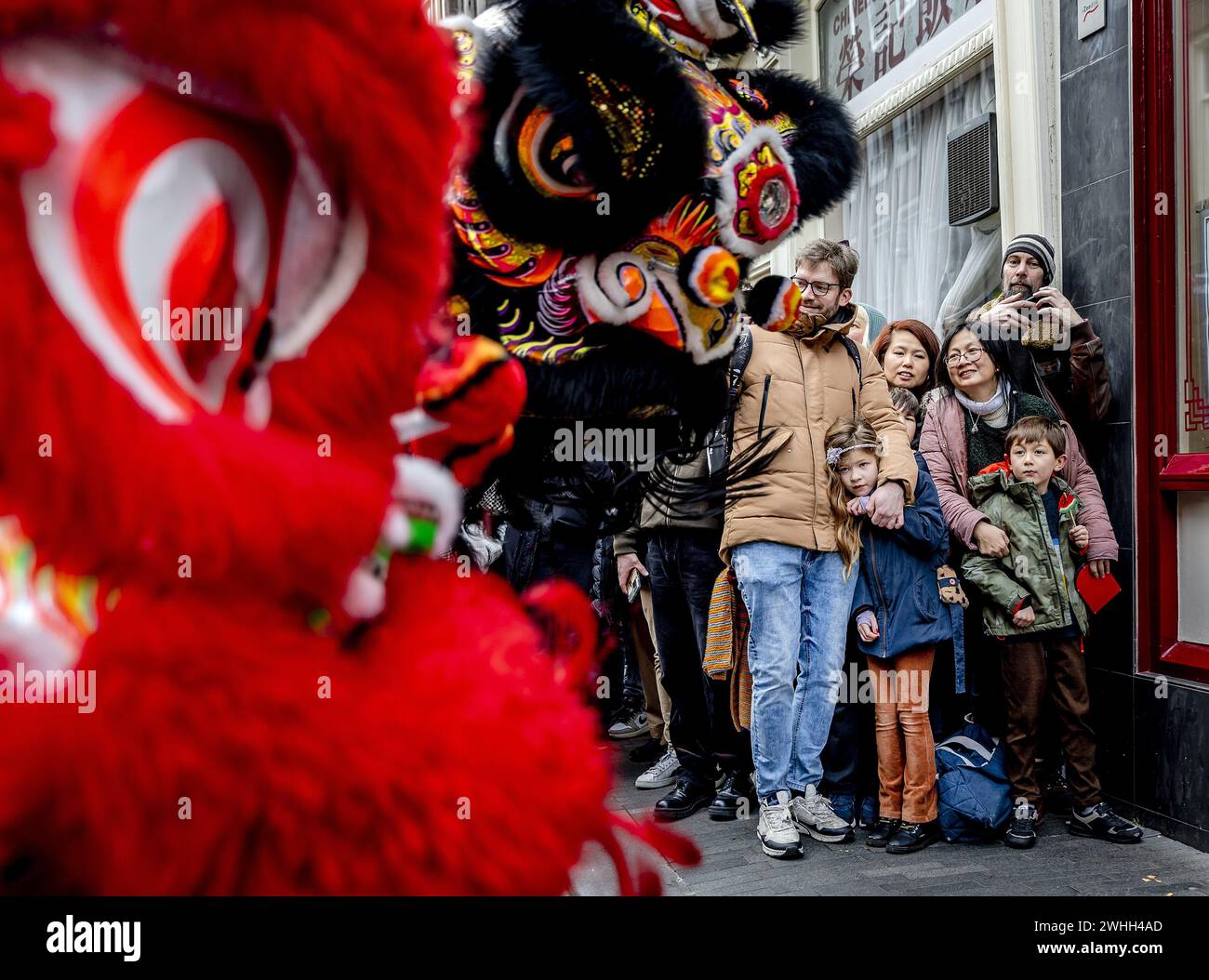 AMSTERDAM - Spectators during a traditional parade of lions and dragons ...