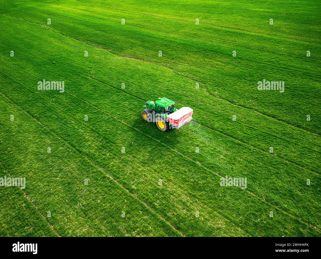 Aerial view of a tractor spraying the field. Chemistry in agriculture ...